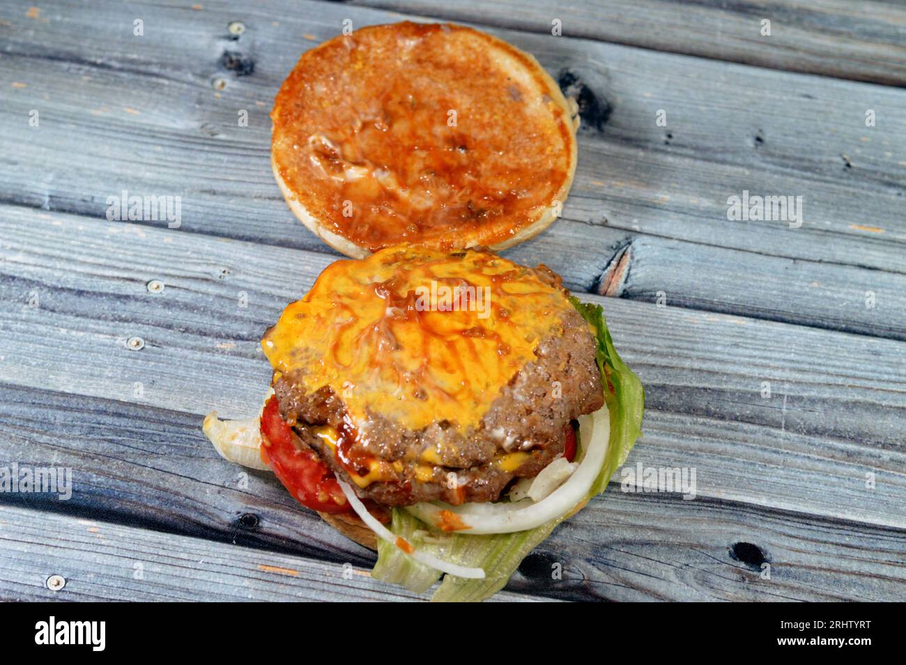 A juicy thick double beef patty with cheese covered with sauce, crispy ...
