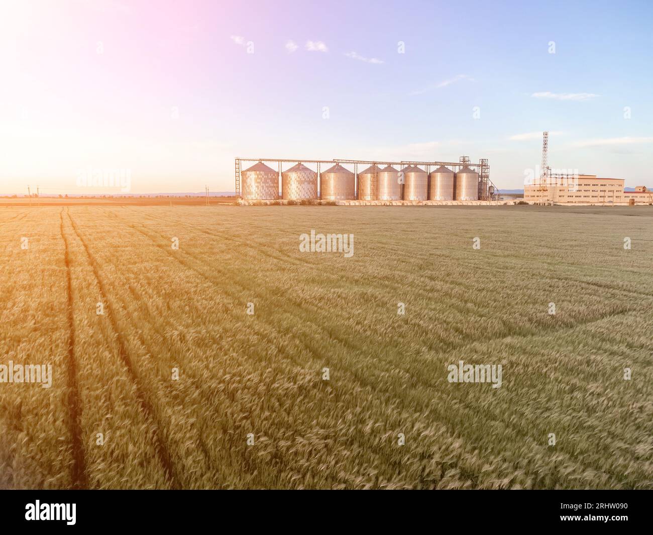Modern metal silos on agro-processing and manufacturing plant. Aerial ...
