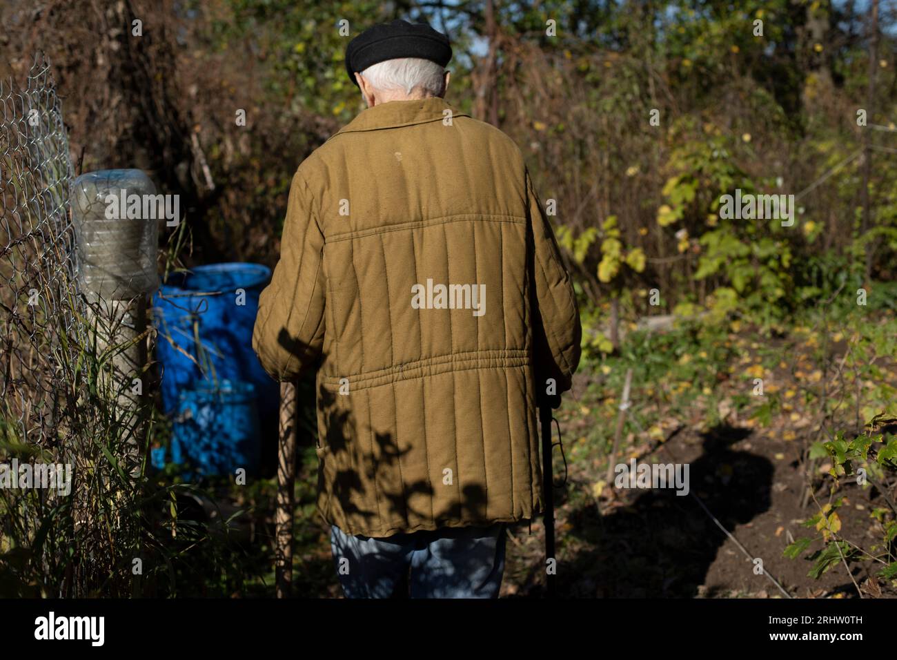 Old man at barrel of water. Old man in Russia. Man in 20th century ...