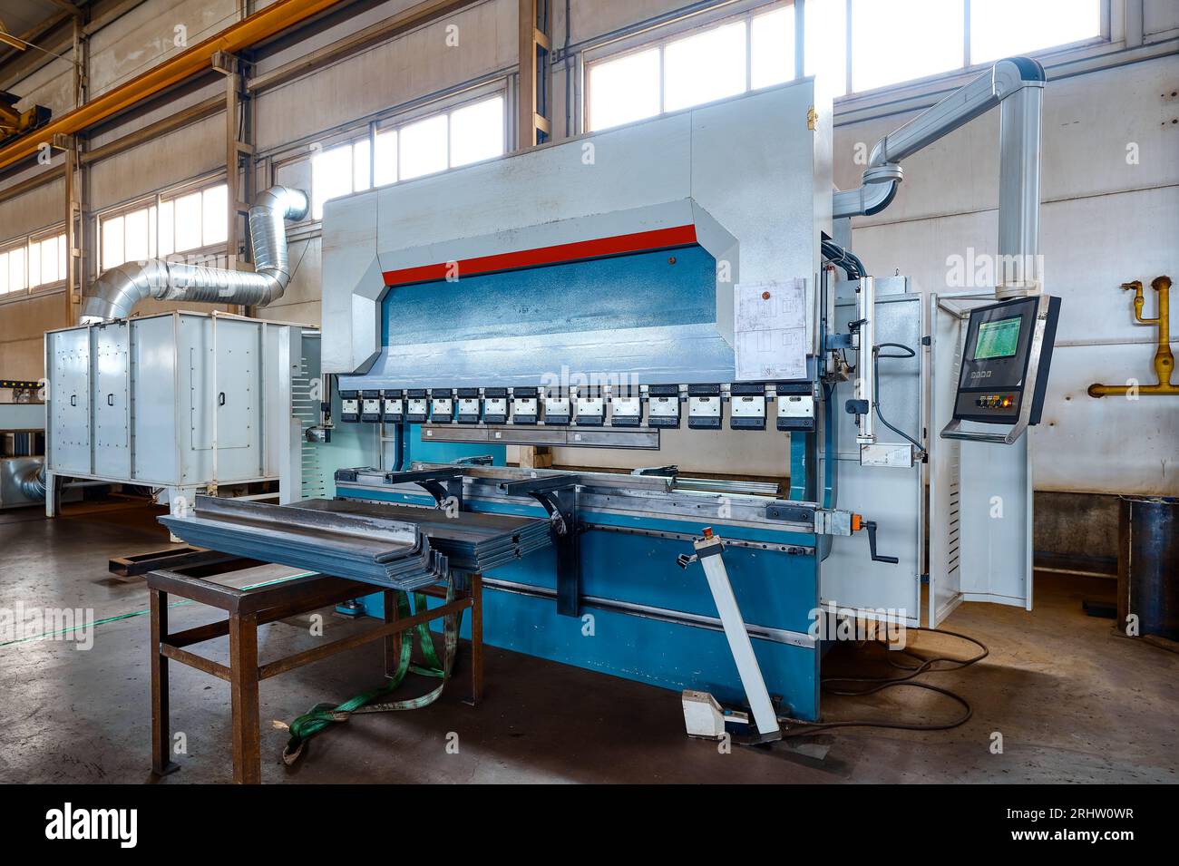 Powerful bending press to process metal sheets at plant Stock Photo - Alamy