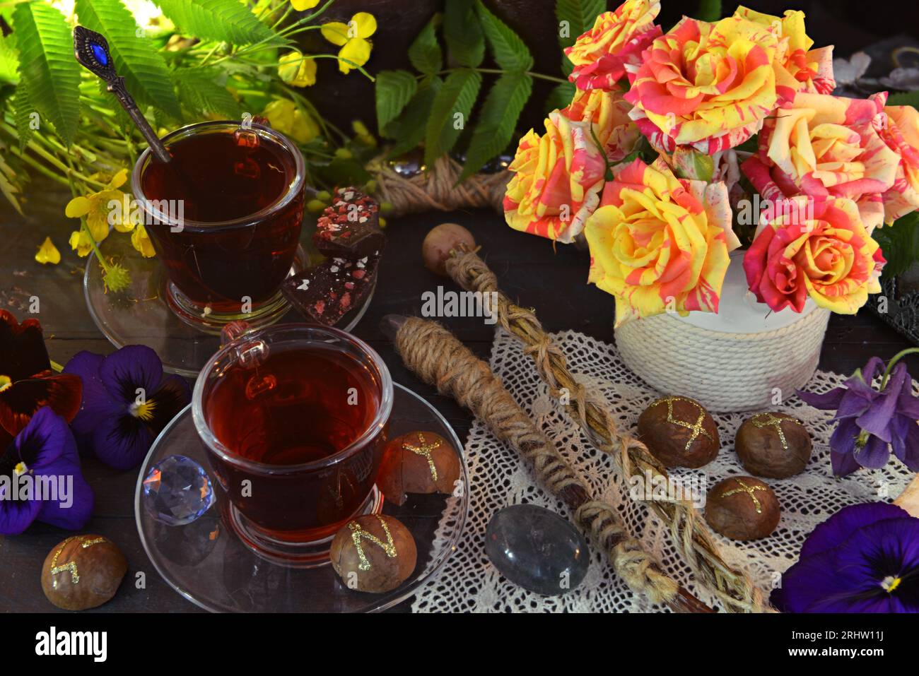 Still life with magic wannds, cups and flowers on witch ritual table ...