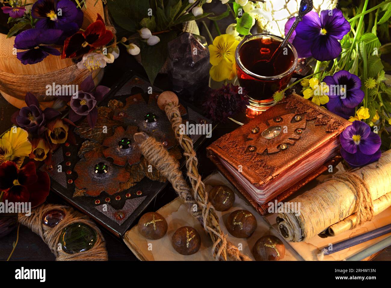 Still life with magic wands, parchments and scrolls with runes on witch ...