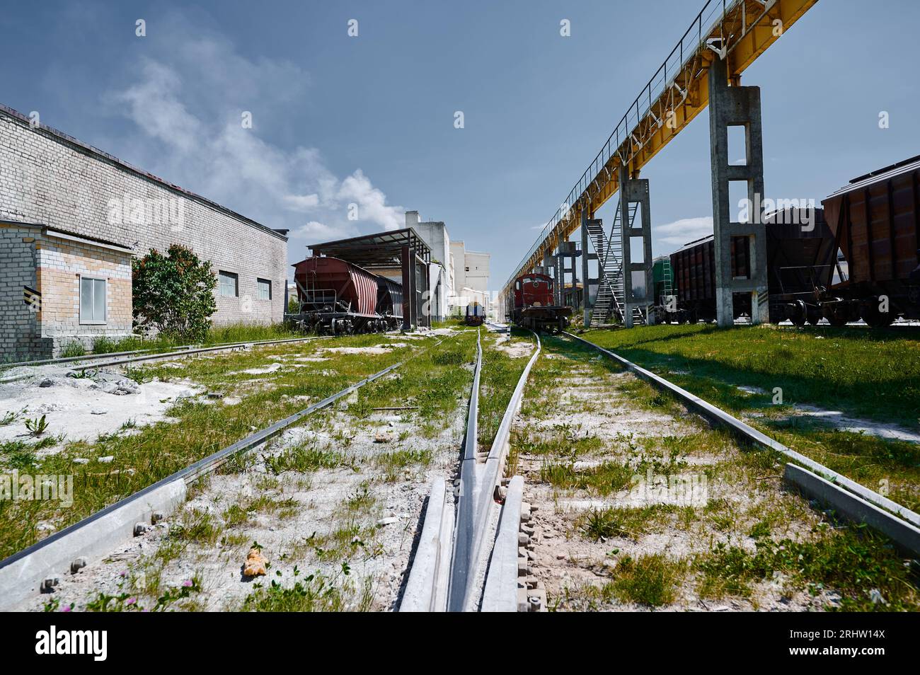 Small diesel locomotive on railway tracks in factory yard Stock Photo ...