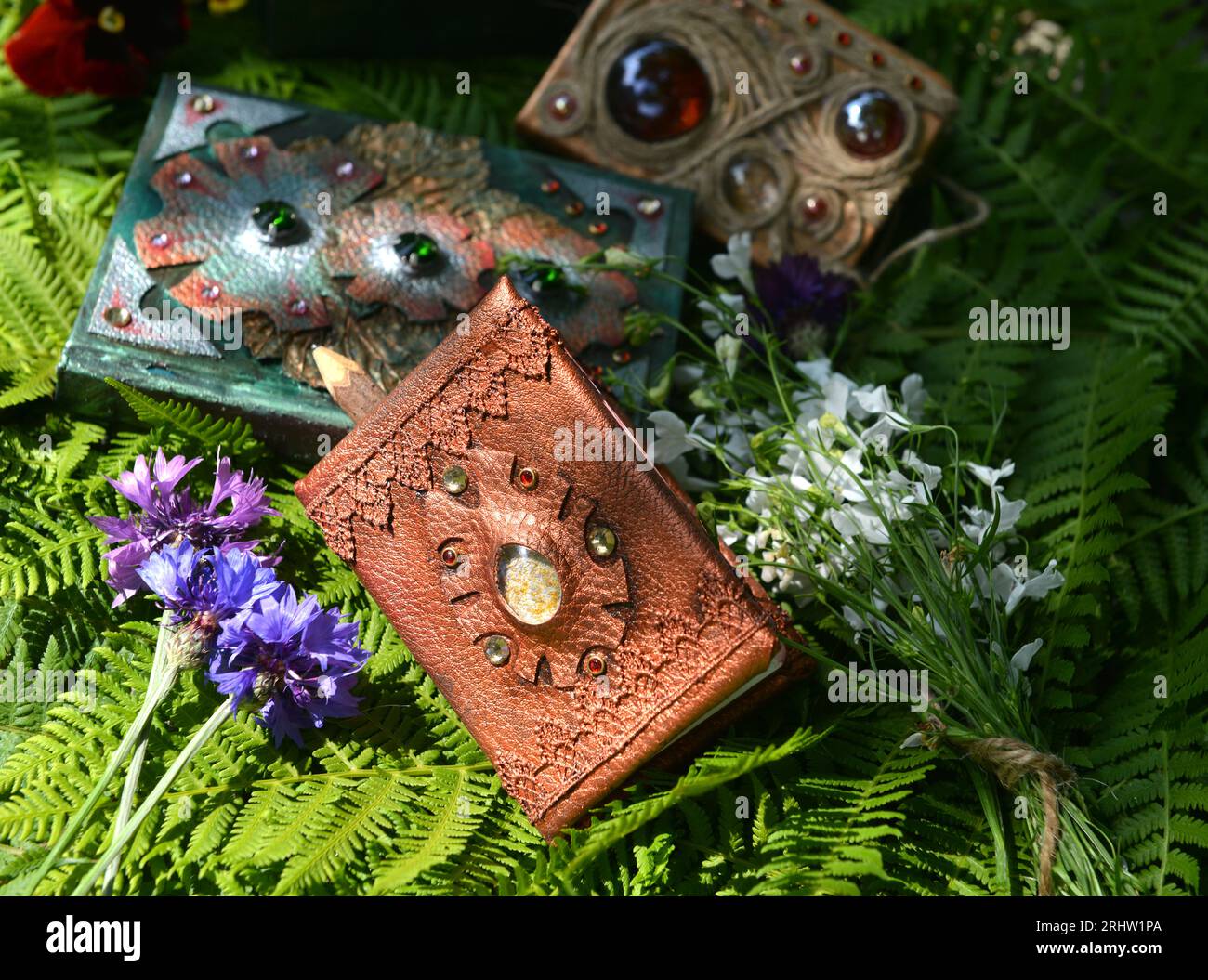 Still life with beautiful magic book of spells or diary with flowers ...