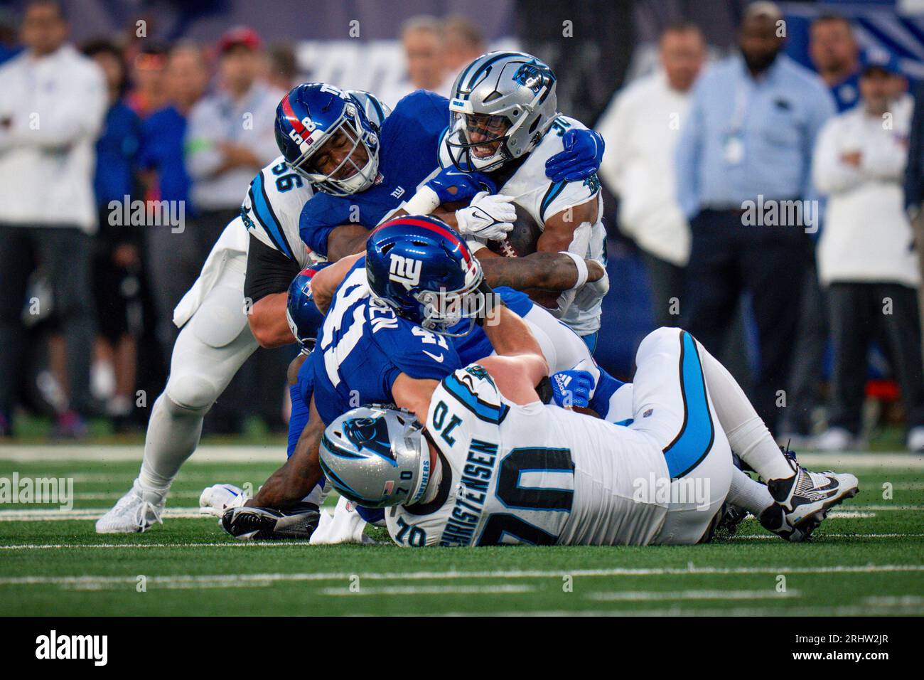 Carolina Panthers running back Chuba Hubbard, right rear, is tackled by ...