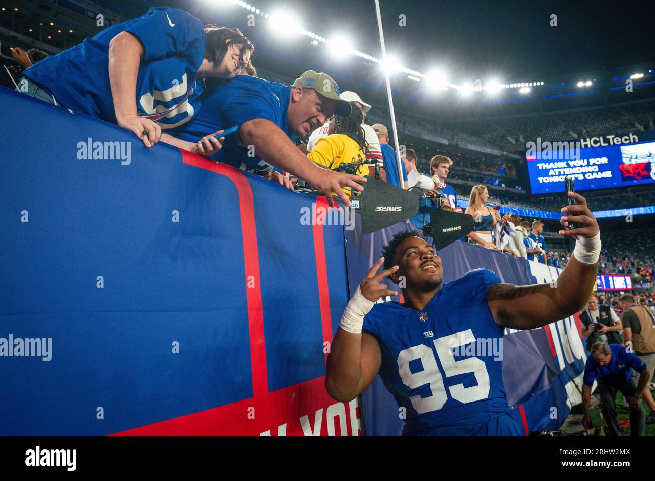 New York Giants defensive tackle Jordon Riley (95) takes a selfie with ...