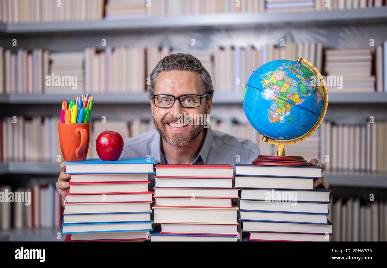 Teacher in school classroom. teacher with book in library classroom ...