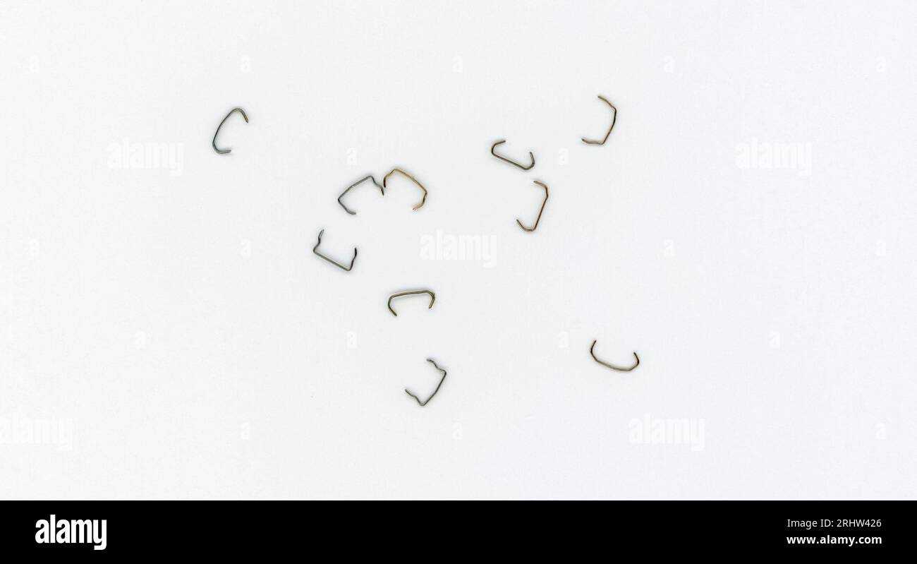 staples over a white paper background with copy space Stock Photo - Alamy