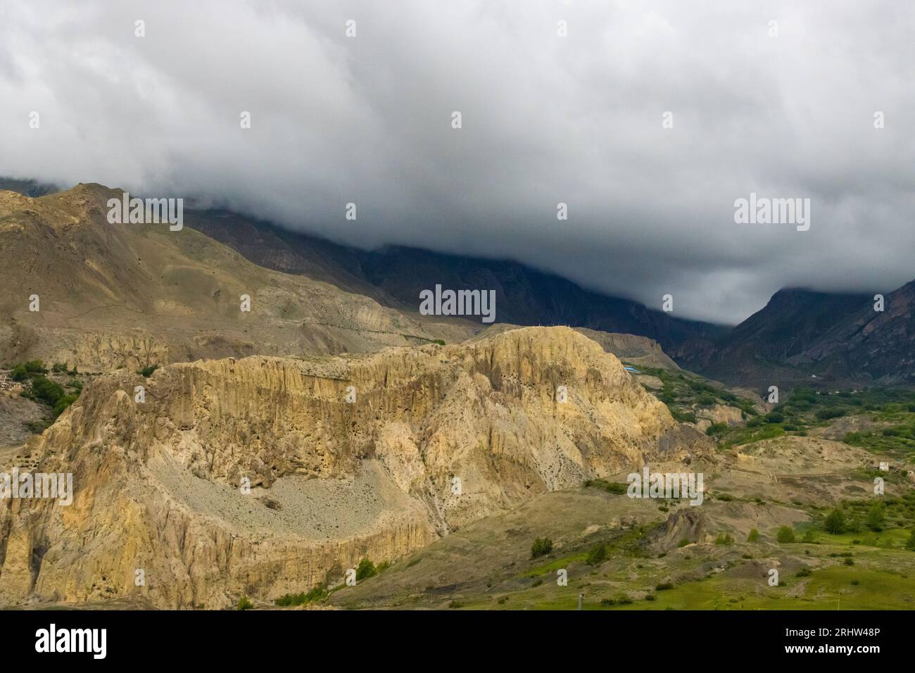 Dark Dramatic Desert Landscape with Foggy Mountains and Distant Houses ...