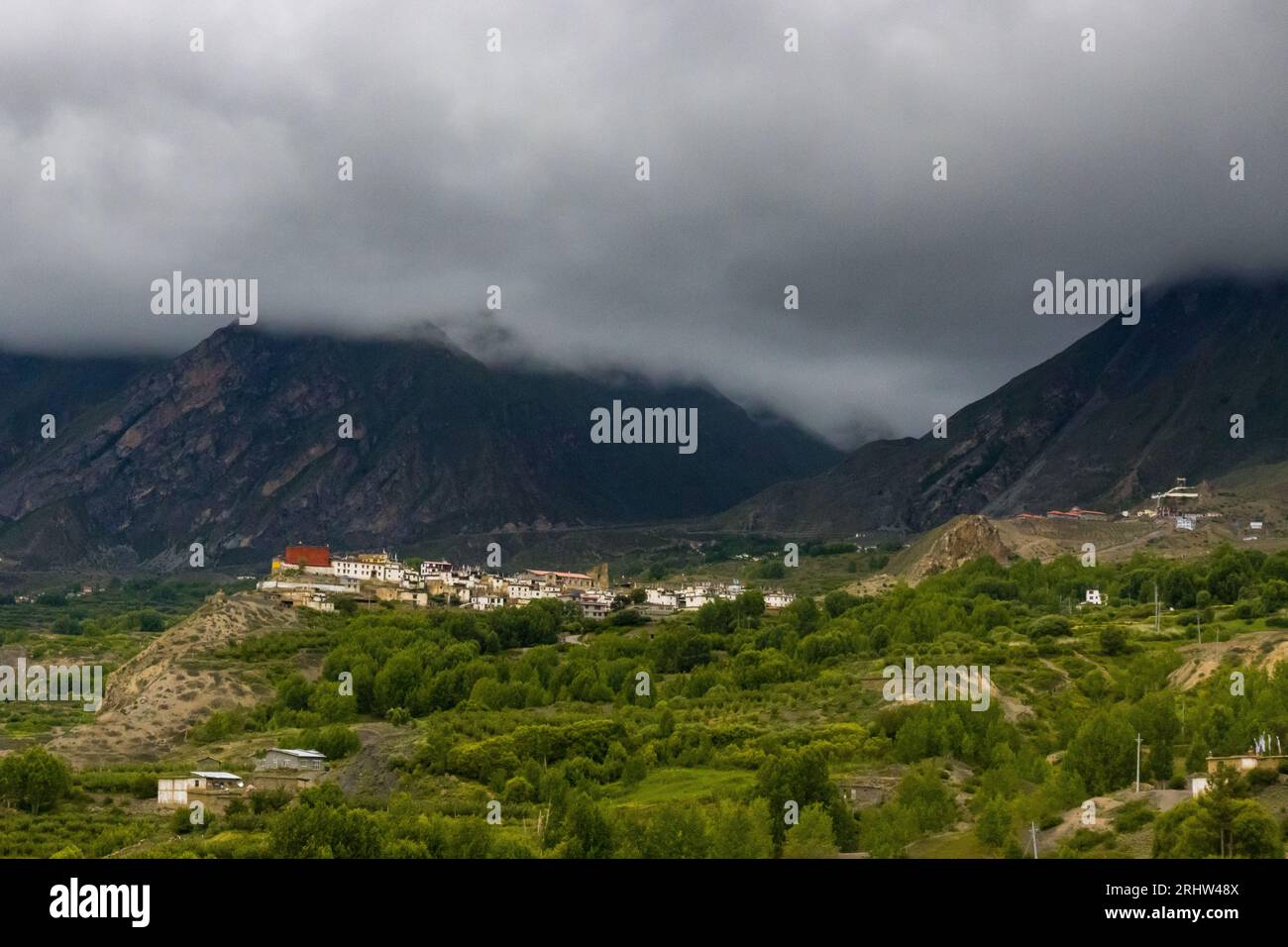 Dark Dramatic Desert Landscape with Foggy Mountains and Distant Houses ...