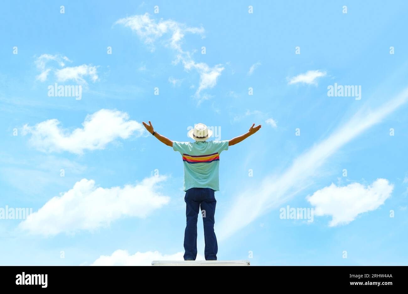 Happy Man Raising Arms to the Bright Blue Sunny Sky Stock Photo - Alamy