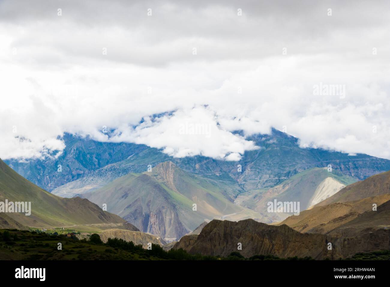 Dark Dramatic Desert Landscape with Foggy Mountains and Distant Houses ...