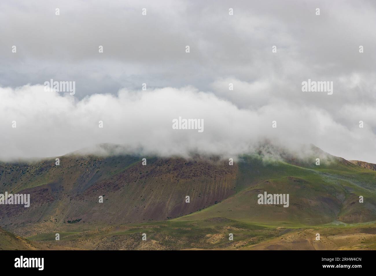 Dark Dramatic Desert Landscape with Foggy Mountains and Distant Houses ...