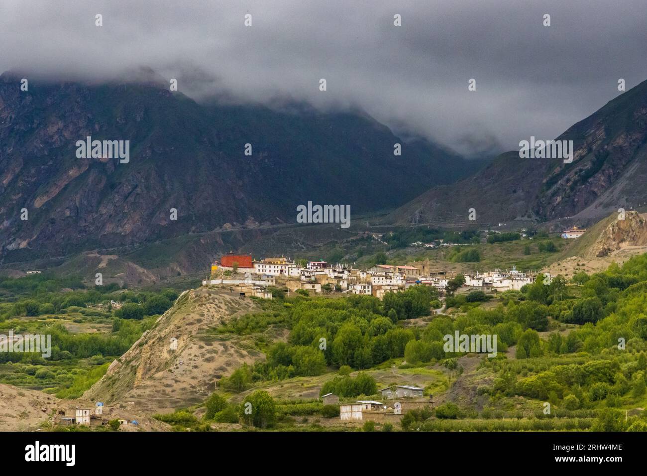 Dark Dramatic Desert Landscape with Foggy Mountains and Distant Houses ...