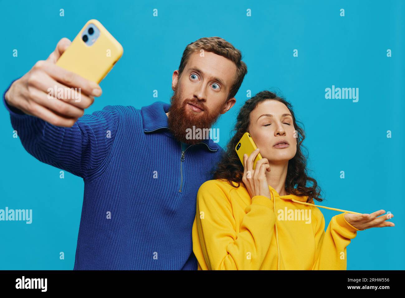 Woman and man funny couple with phones in hand taking selfies crooked ...
