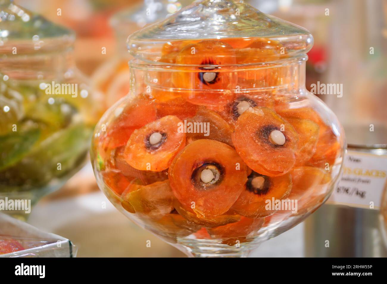 Whole candied glazed clementine citrus fruit on display at a ...