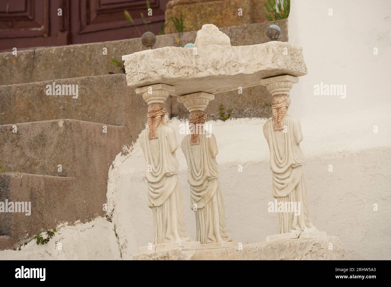 Little replicas of ancient statues near residential house in Lindos on ...
