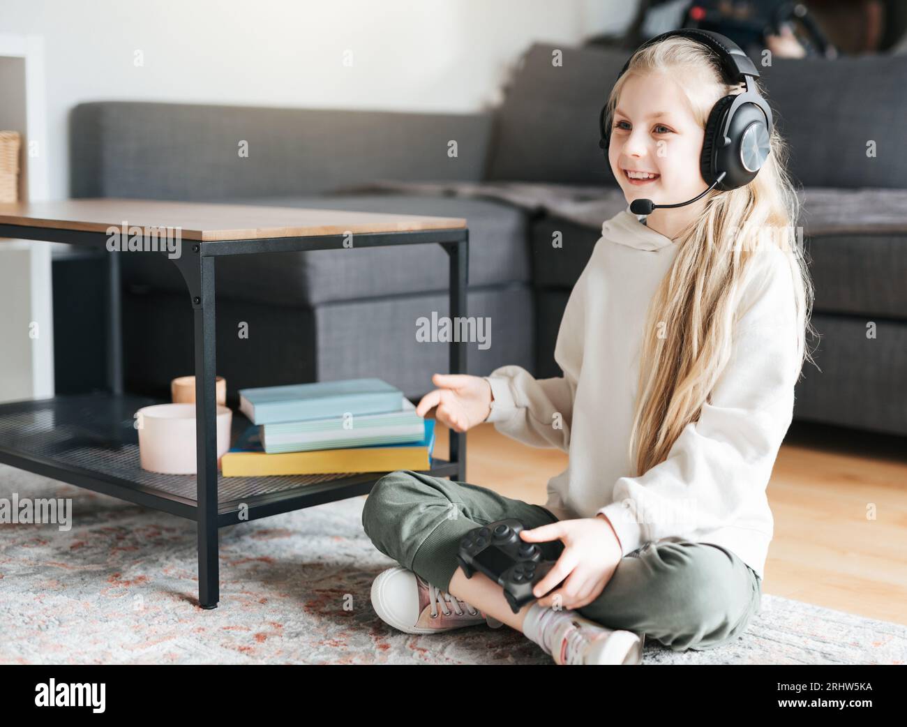 A little girl holding game controller playing video games Stock Photo ...