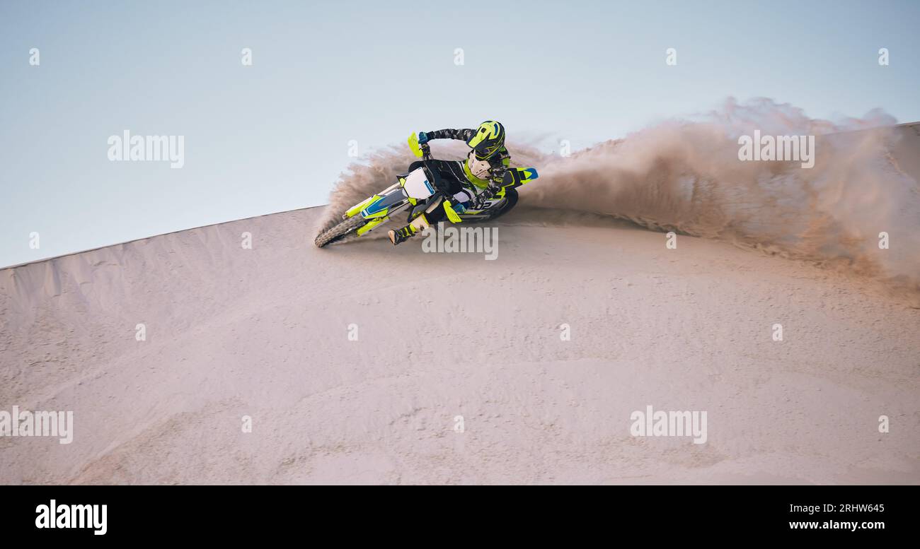 Bike, sand and space with a sports man riding a vehicle in the desert ...