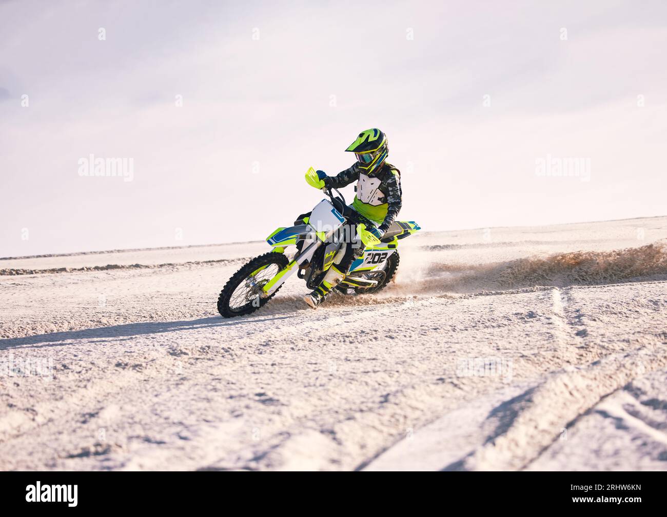 Motorcycle, dust and speed with a sports man riding a vehicle in the ...