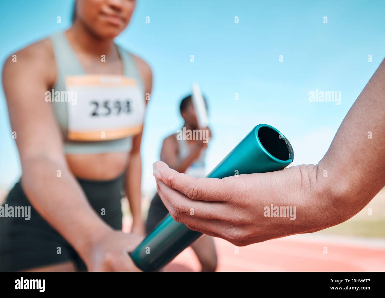 Woman, team and hands with baton in relay, running marathon or sports ...