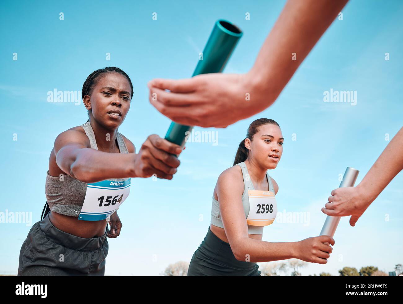 Woman, teamwork and baton in relay, running competition or sports ...