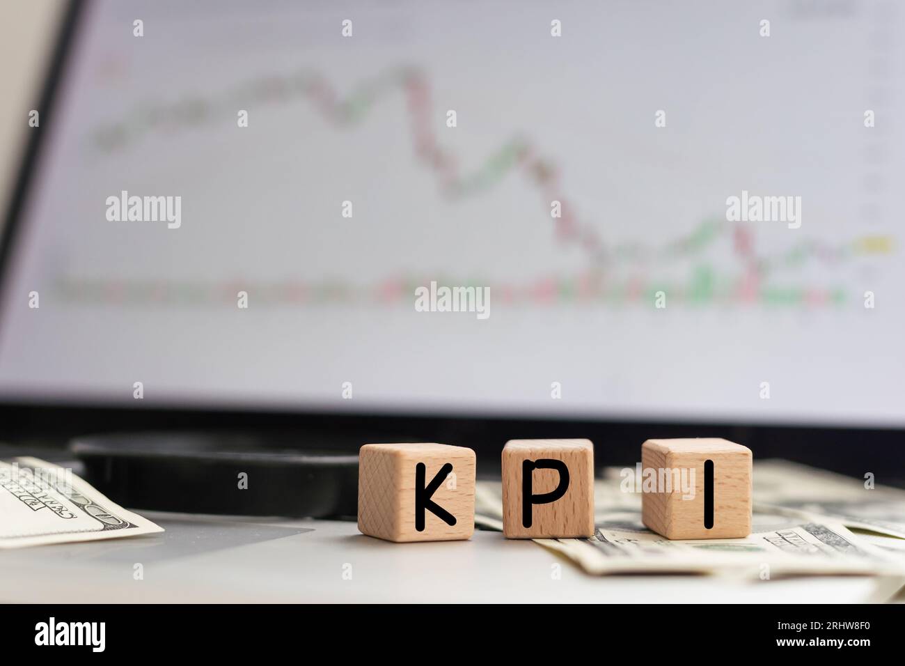 Business Concept with wooden blocks. Text KPI on the chart background ...