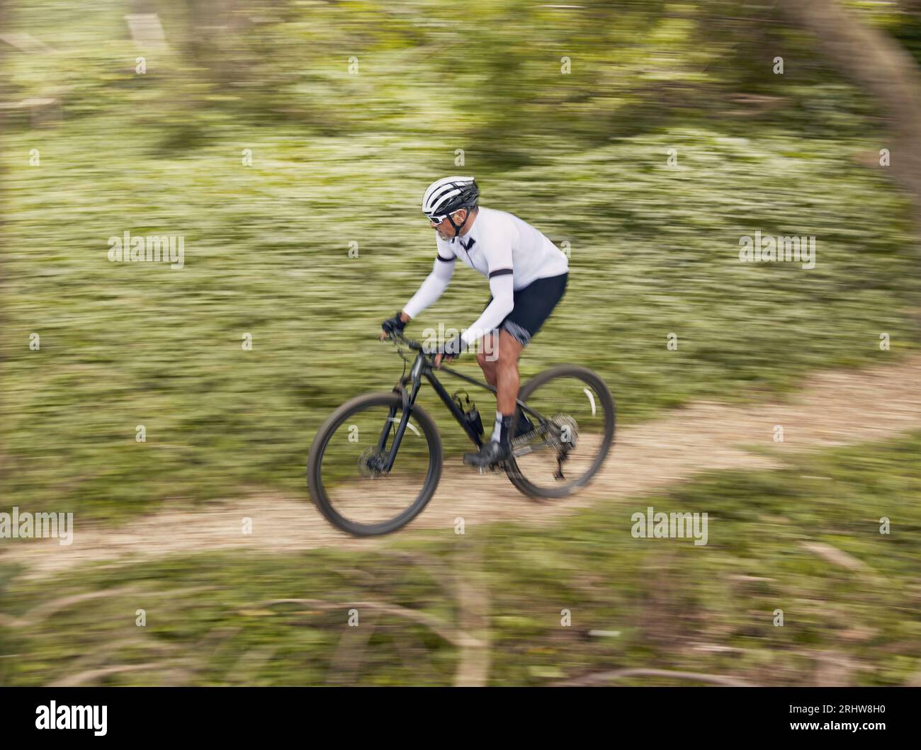 Fitness, sports and man cycling in forest for speed, training or nature ...