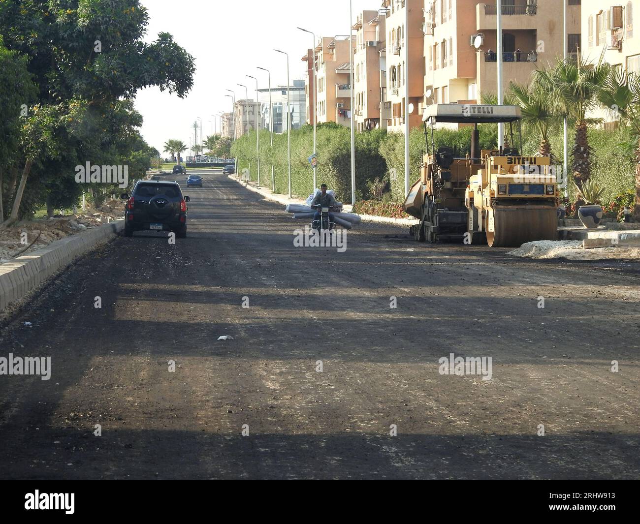 Cairo, Egypt, July 19 2023: the process of paving a road and making ...