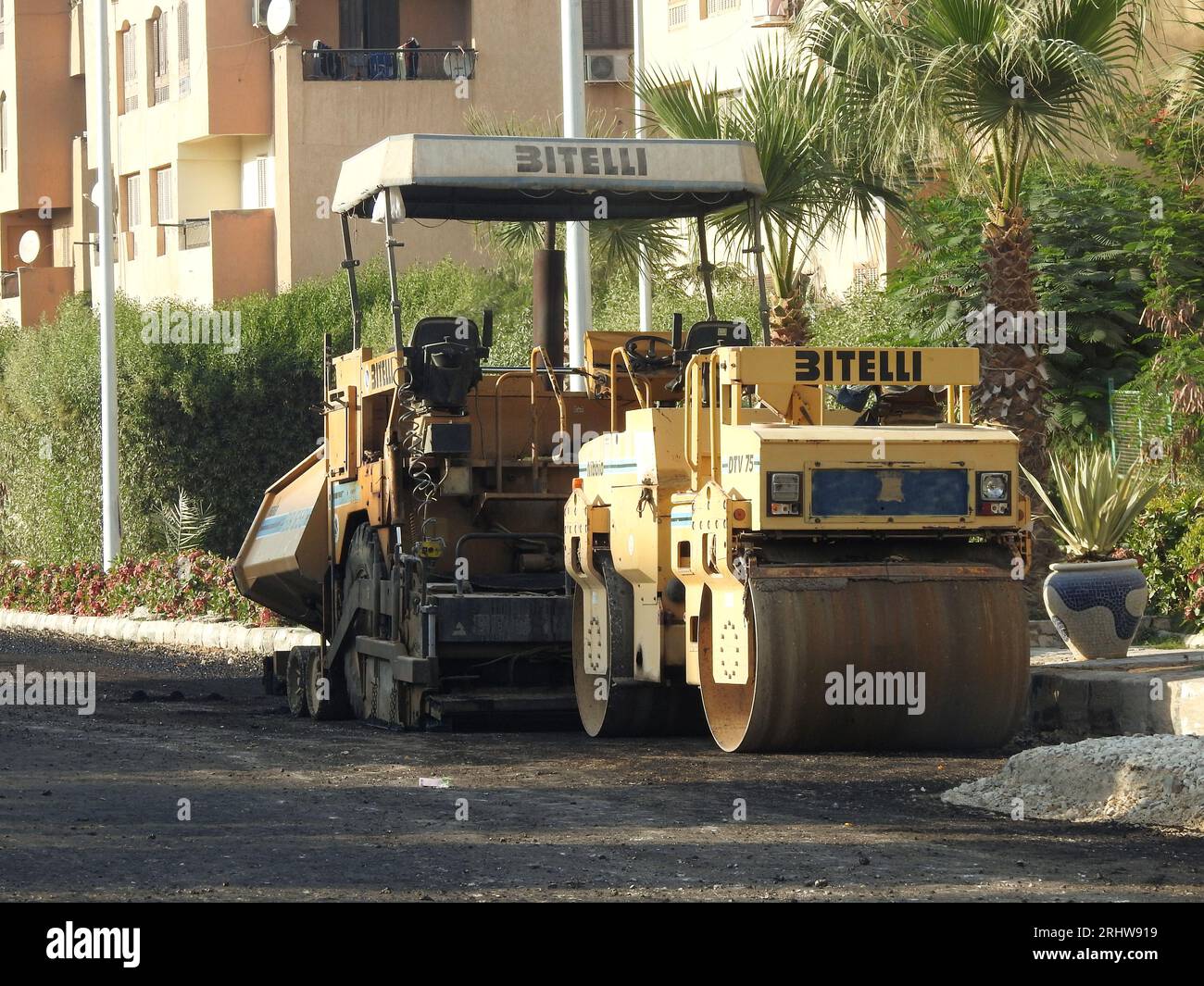 Cairo, Egypt, July 19 2023: Asphalt paver trucks and compactors, A ...