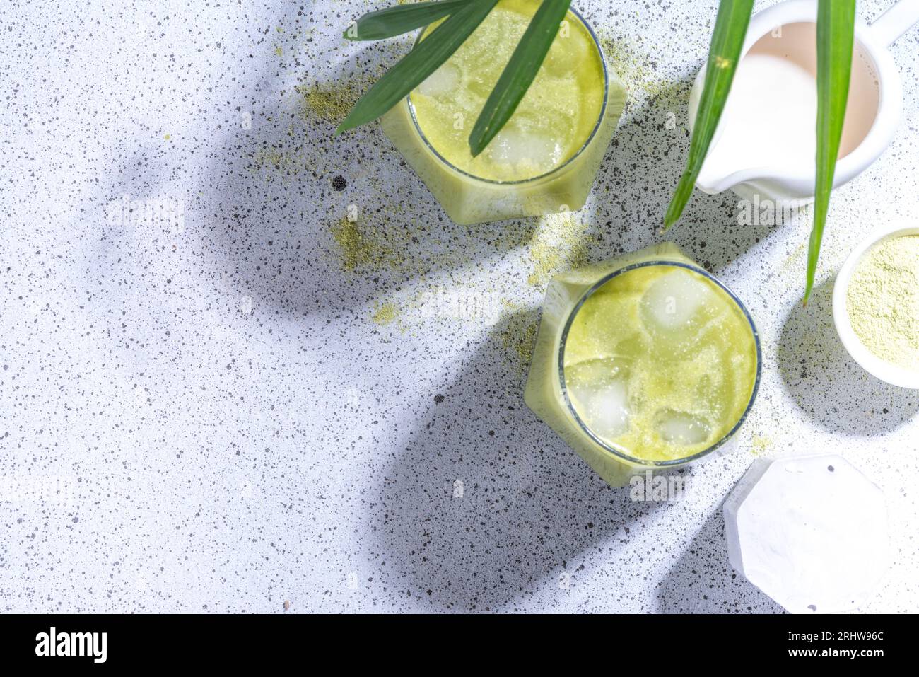 Cold matcha green tea drink. Iced matcha latte cocktail in two glasses ...