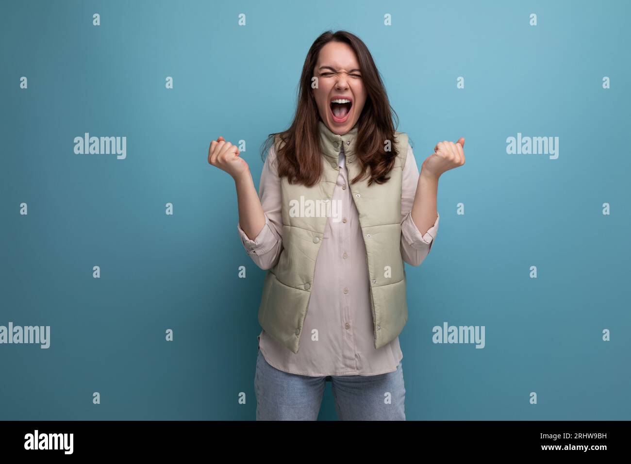 happy cute young brunette woman screaming with joy Stock Photo - Alamy
