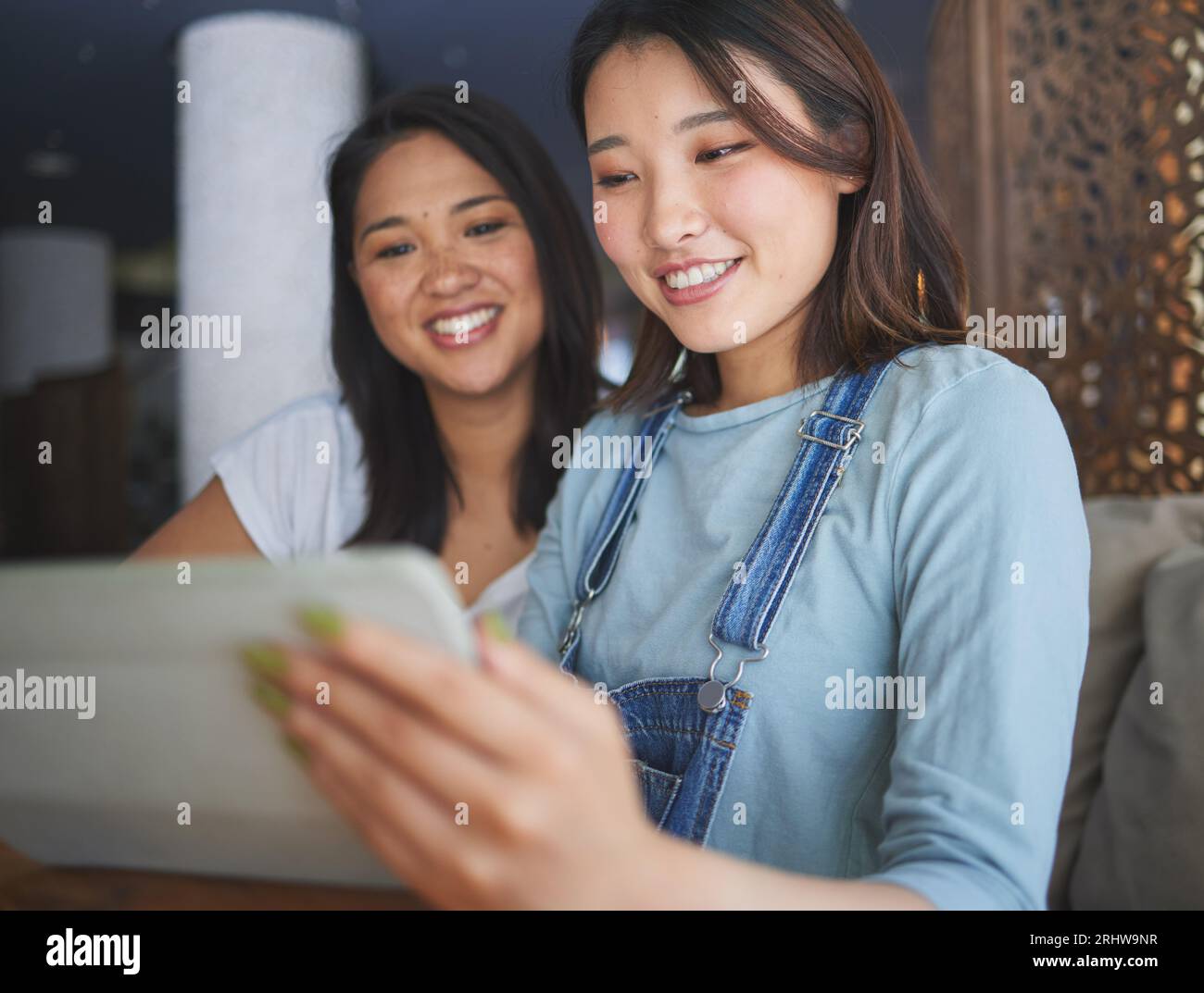 Restaurant, tablet and Asian women for online menu, food options and ...