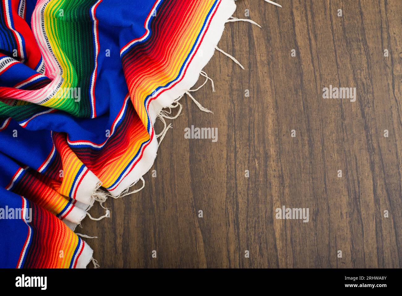 Colorful serape on wooden table. Typical colorful fabric from Mexico ...