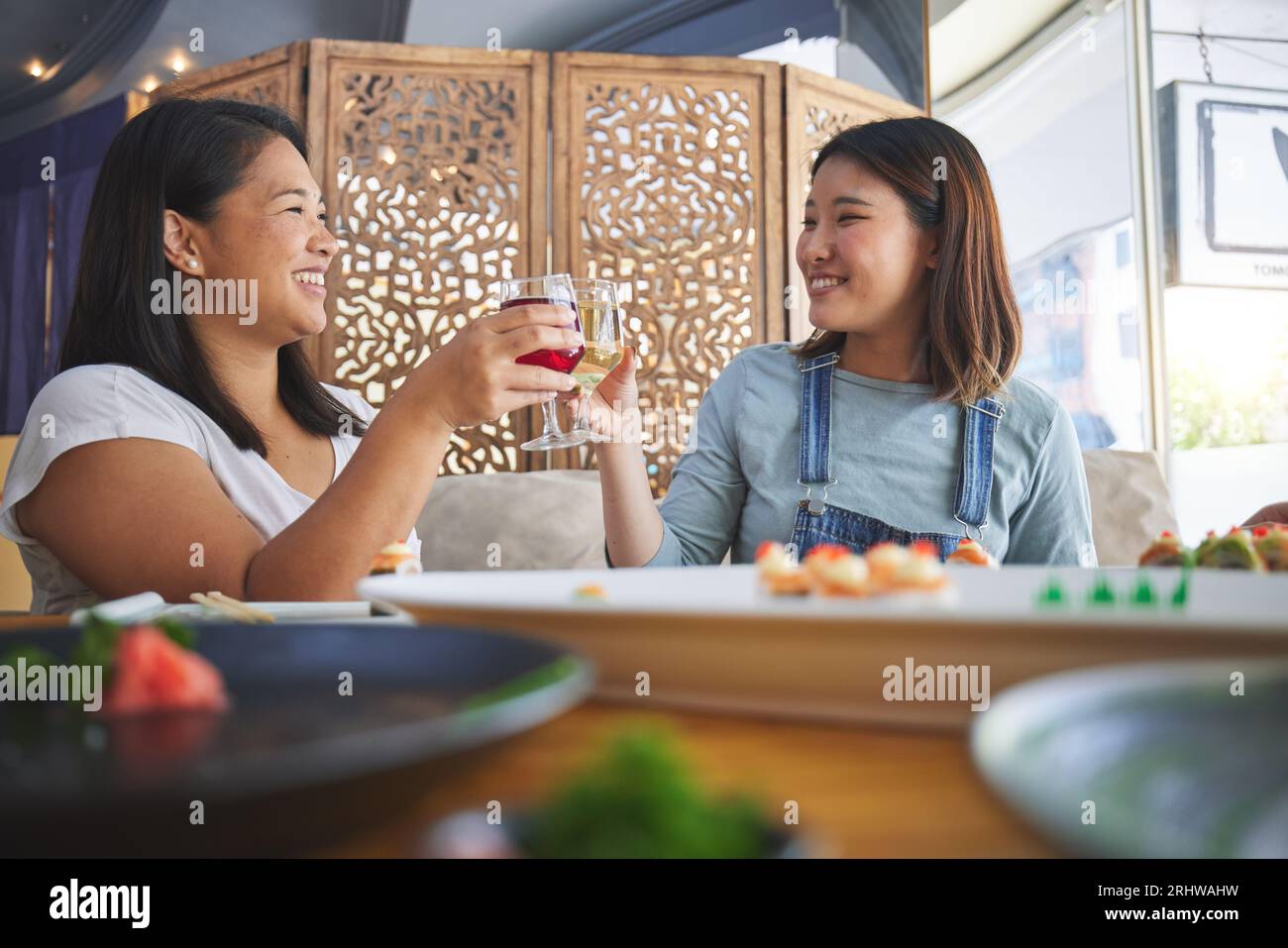 Japanese women, restaurant and toast with sushi, smile and congratulations with fine dining ...