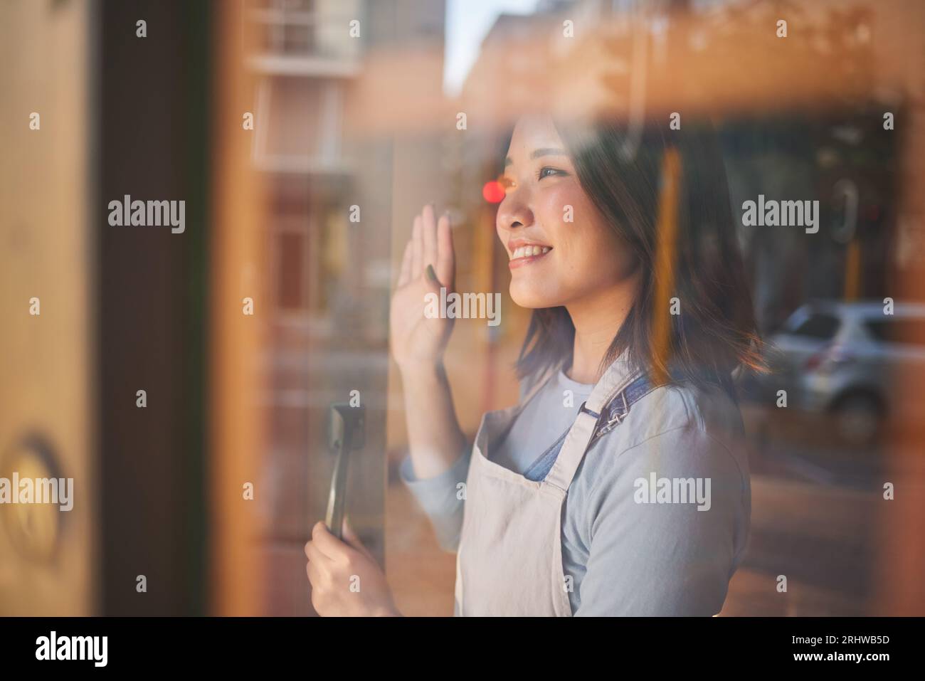Asian woman, window and door of restaurant to welcome service, small ...