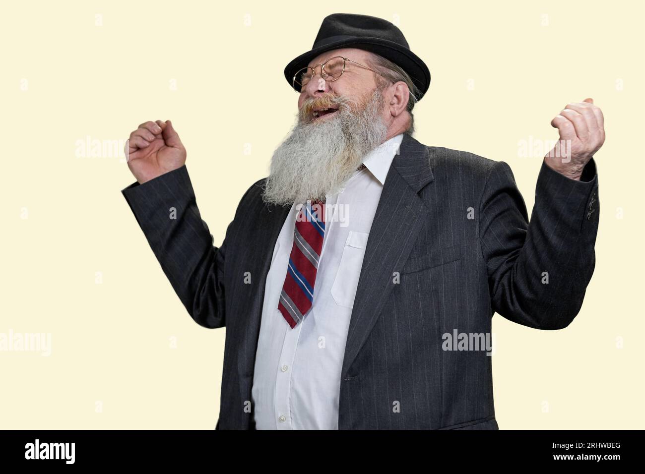 Old man in suit laughing with raised hands. Senior man laughing hard ...