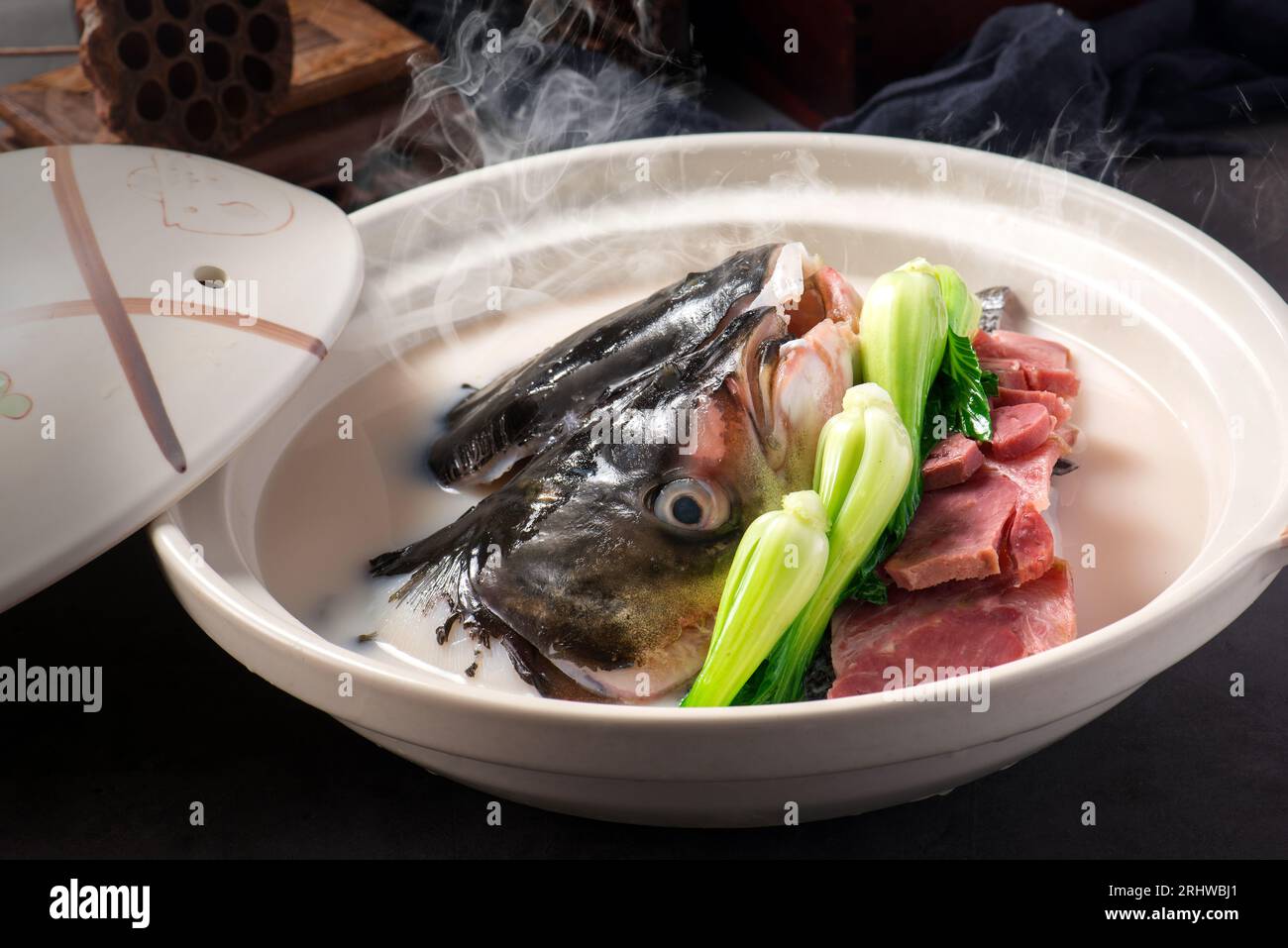 eight treasure fish head soup in casserole Stock Photo - Alamy