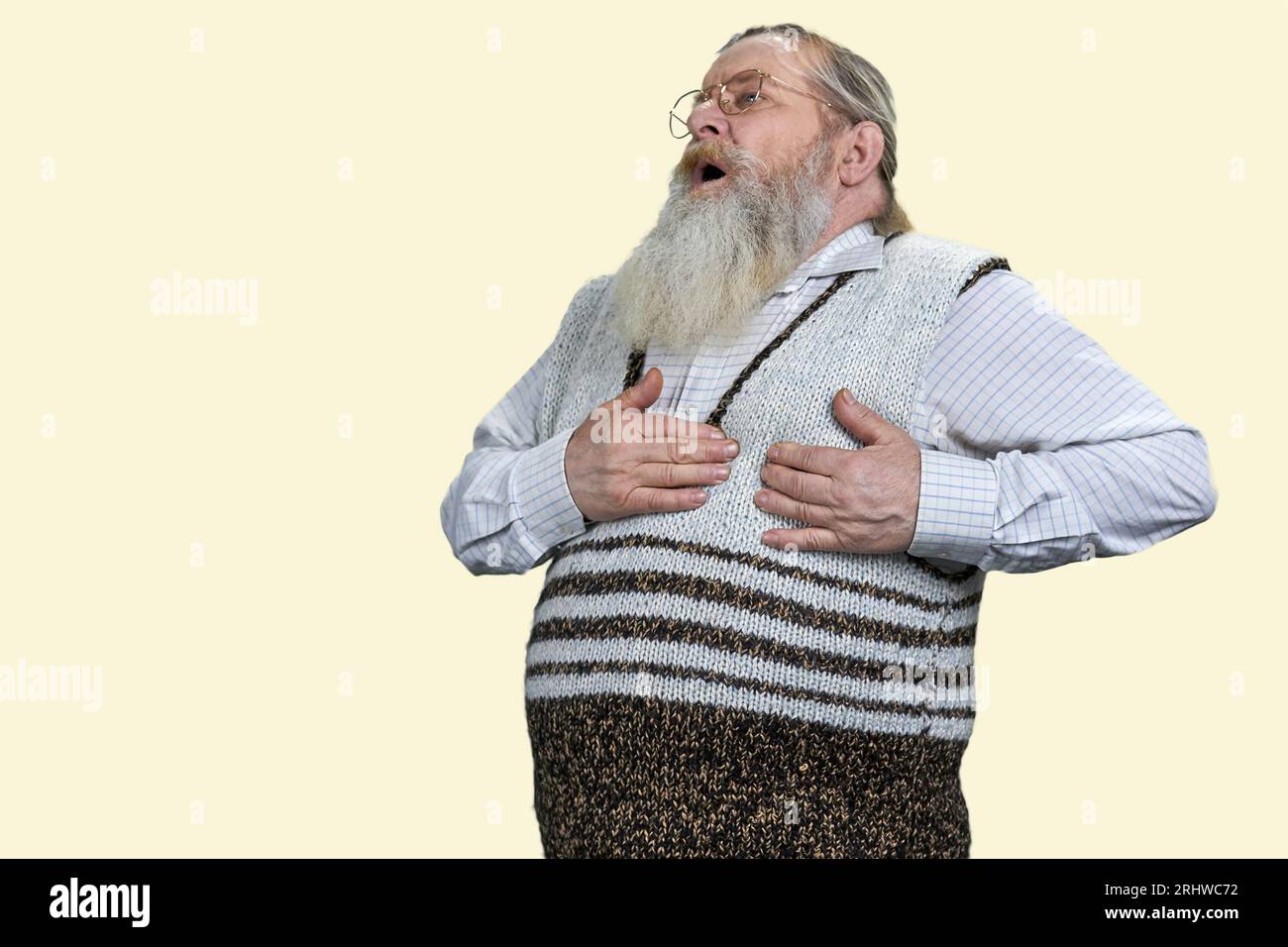 Portrait of senior man suffers from heart attack. Grandpa is pressing ...