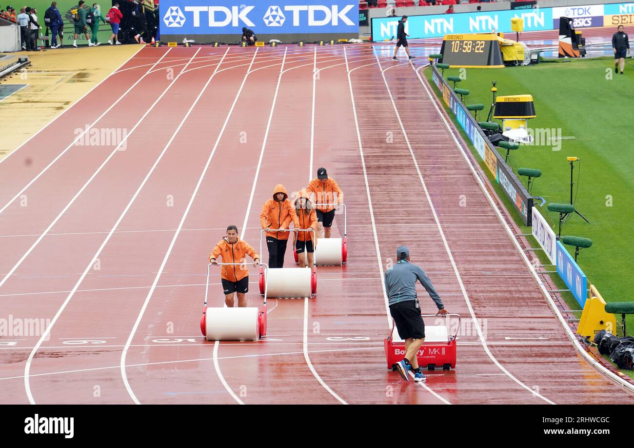 Standing rain water is cleared from the track on day one of the World ...