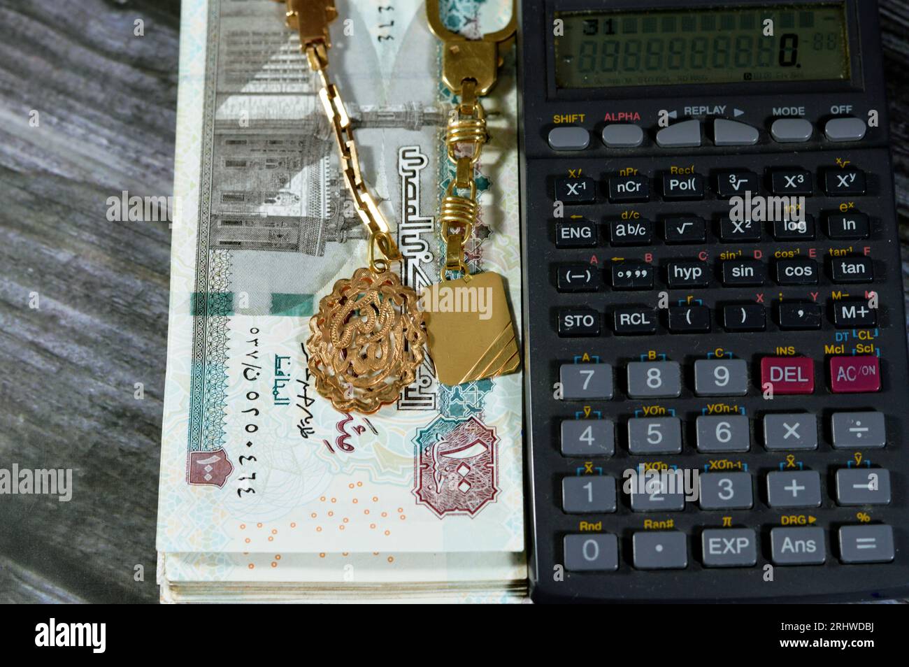 Calculator and golden keyring medals made of gold karat 18 with Arabic ...