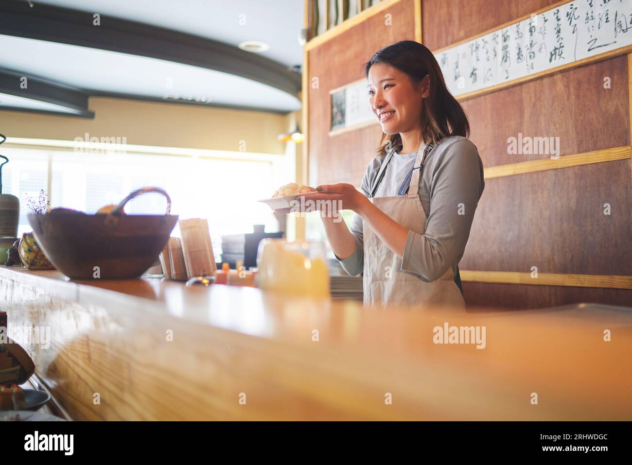 Chinese food, waitress and an asian woman in a sushi restaurant to ...