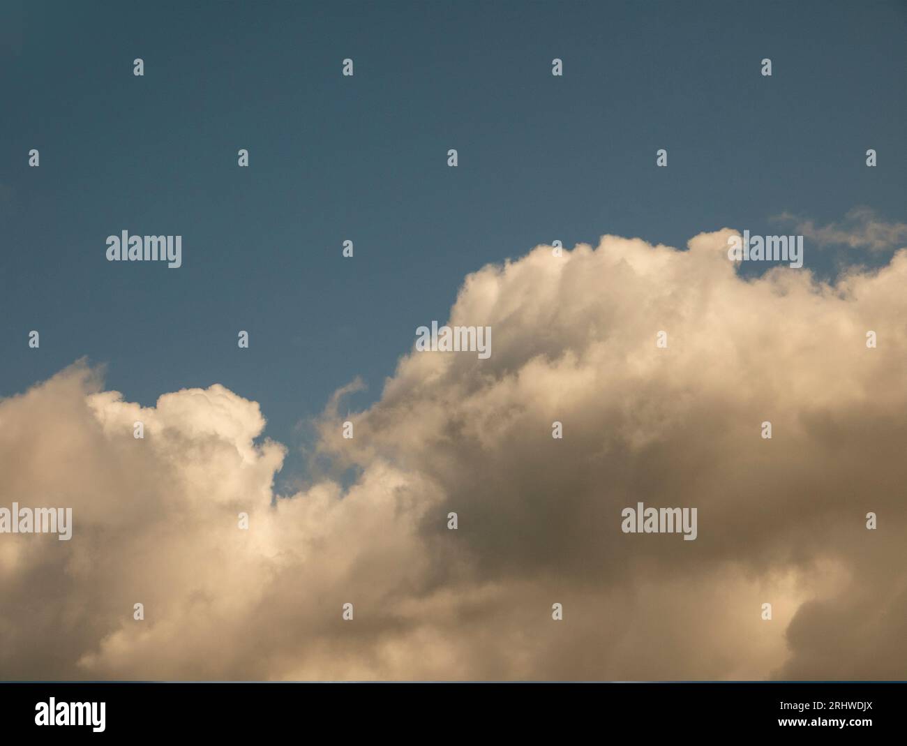 White clouds over sunset sky background. Fluffy cumulus clouds shape ...