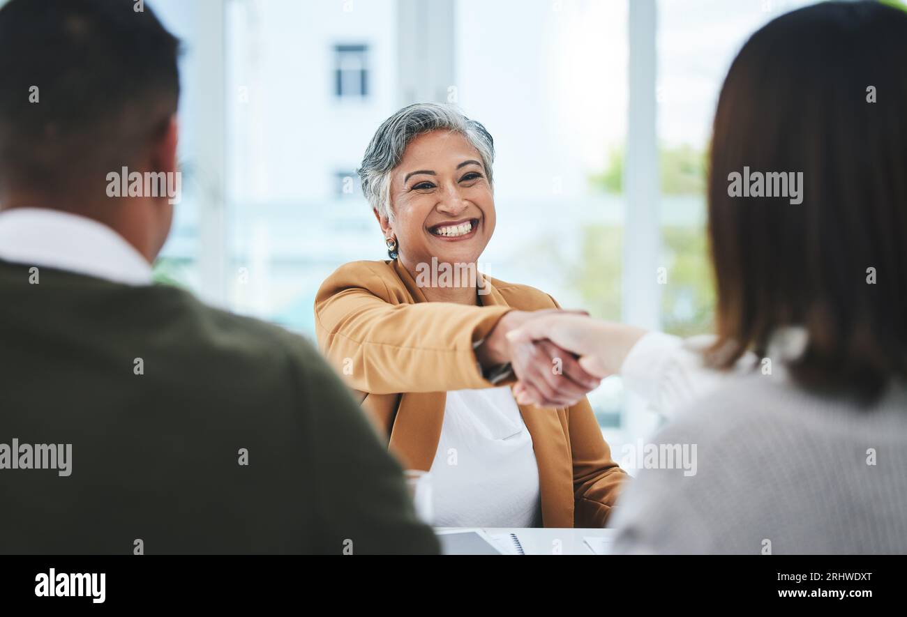 Handshake, job interview or business people with a happy mature woman ...