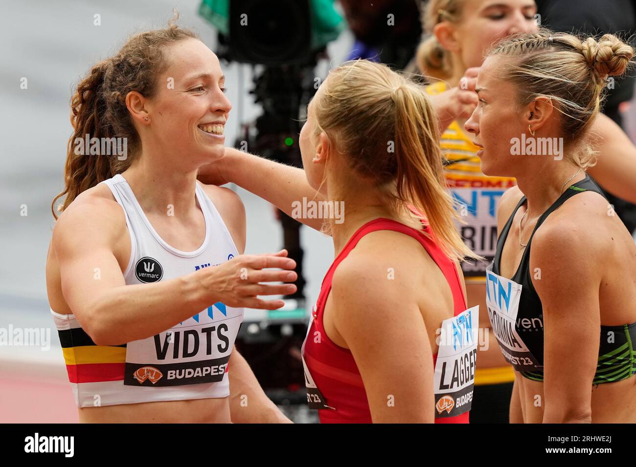 Noor Vidts, of Belgium, left, reacts as she crosses the finish line to ...