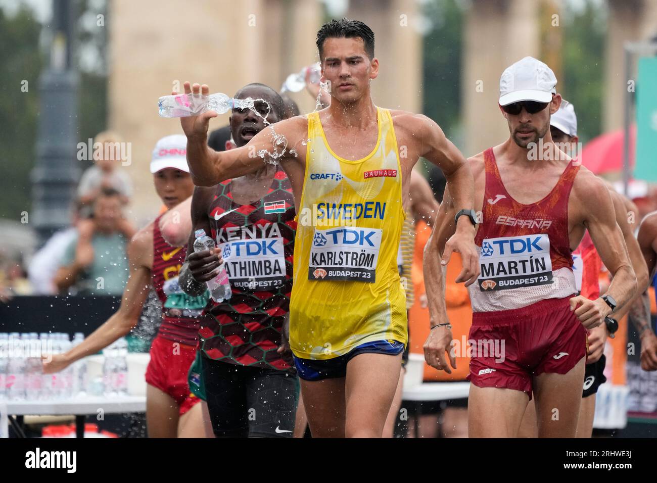 Perseus Karlström, of Sweden, takes on water as he passes a feeding ...