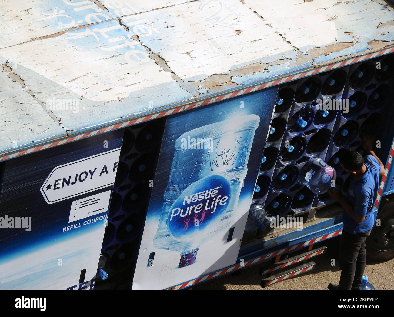 Cairo, Egypt, July 19 2023: Nestle pure Life plastic bottles delivery vehicle, Nestlé S.A., a ...