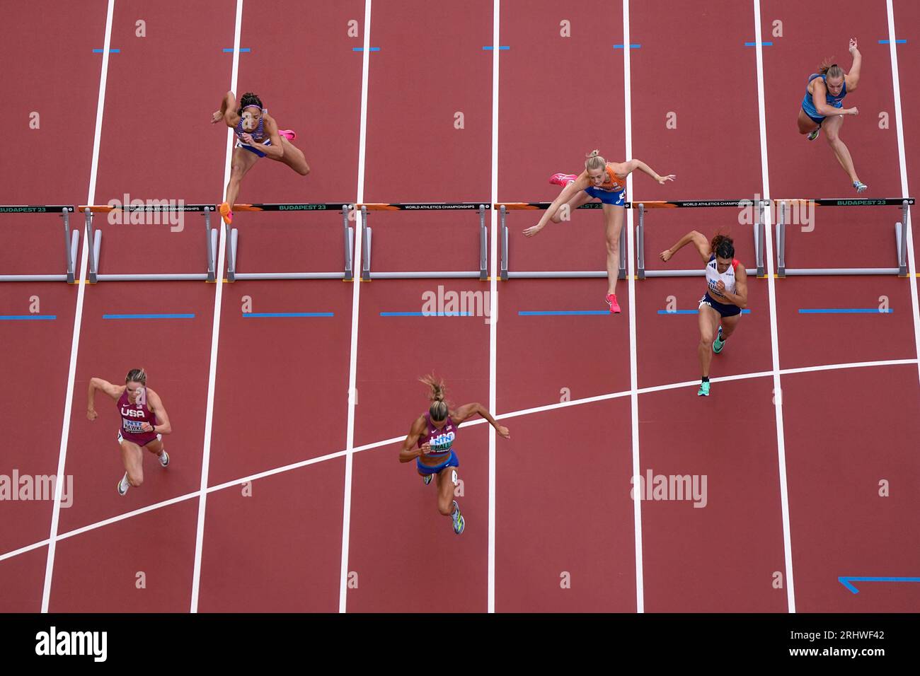 Athletes race toward the finish line during a heptathlon 100-meters ...