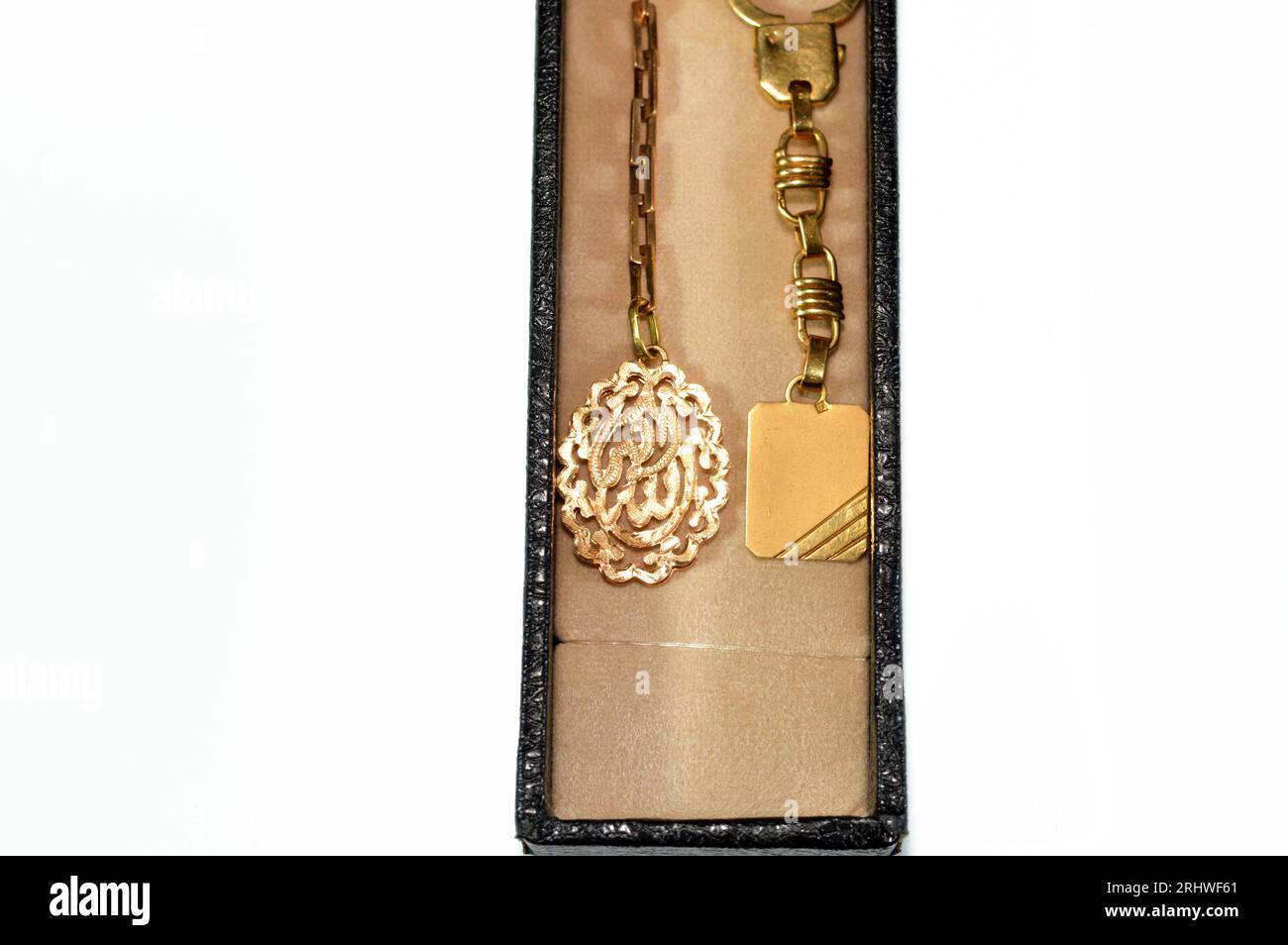 Golden keyring medals made of gold karat 18 with an Arabic text on one ...