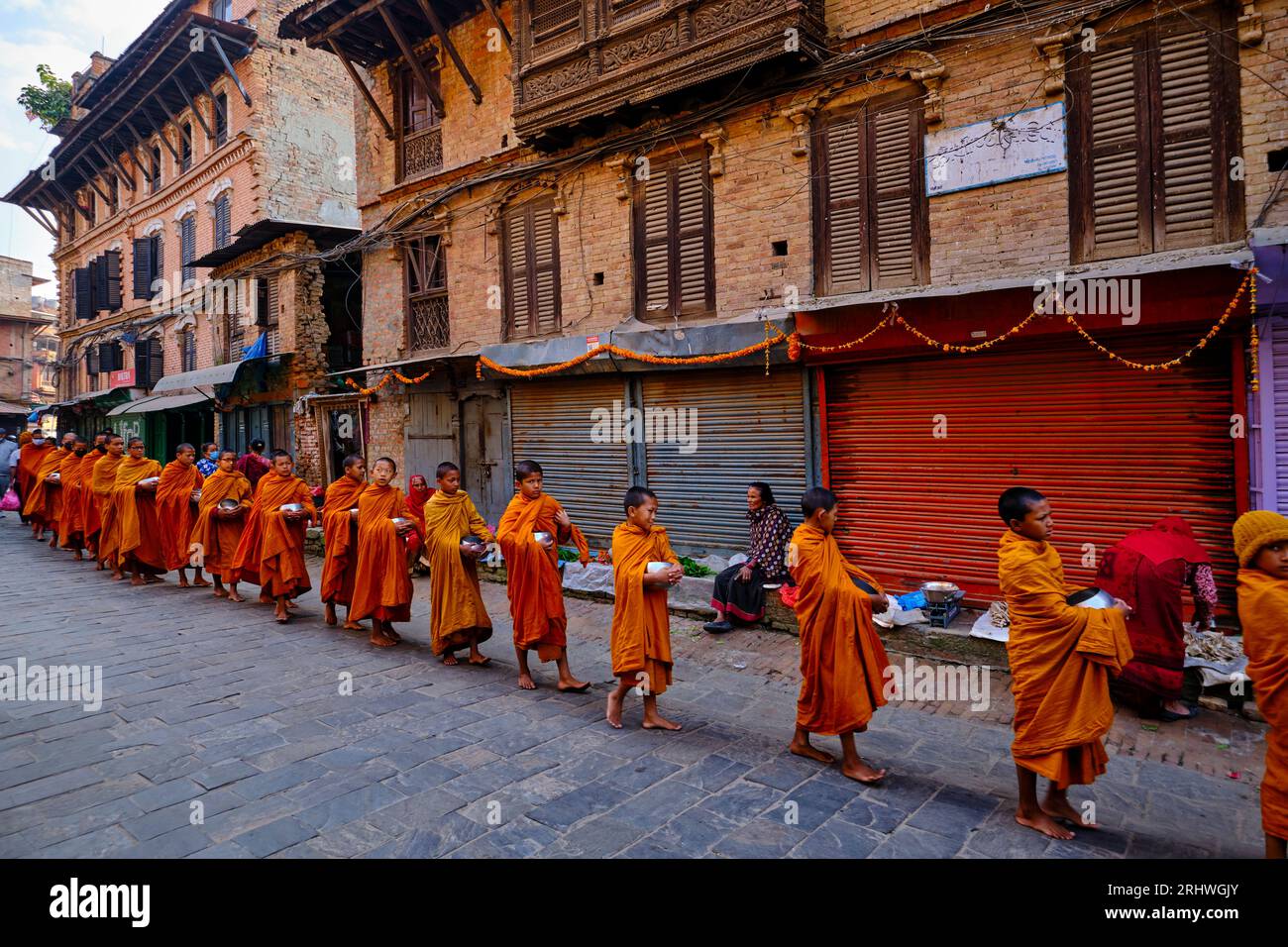Nepal, Kathmandu valley, Bhaktapur city, buddhist monk in alms ...